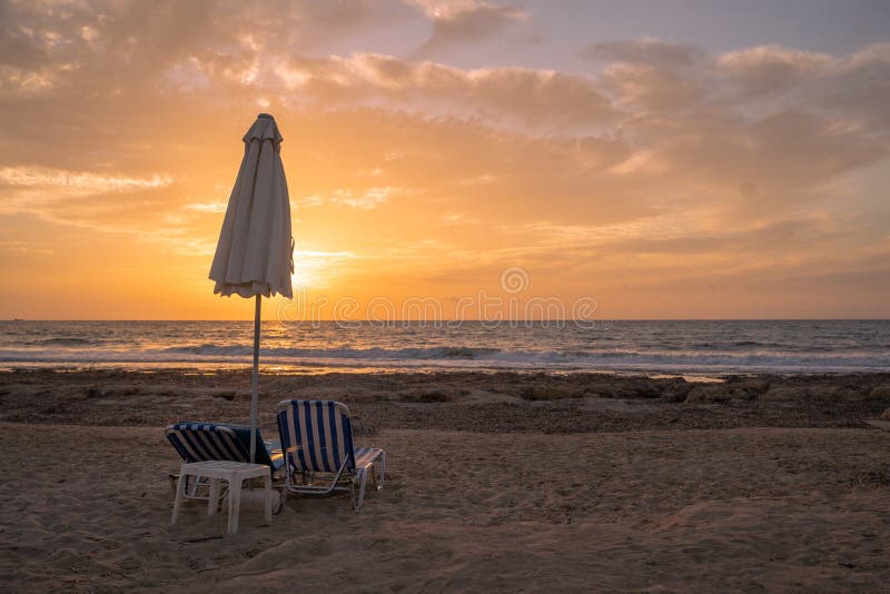 Sunset with Two Sun Loungers and a Beach Umbrella Stock Photo - Image ...