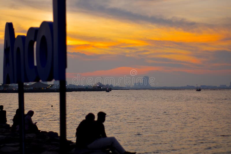 Sunset View on the Beach and Sunset Shadow of People Sitting Stock ...