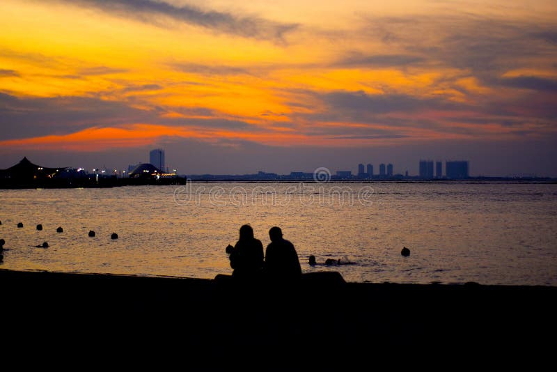 Sunset View on the Beach and Sunset Shadow of People Sitting Stock ...