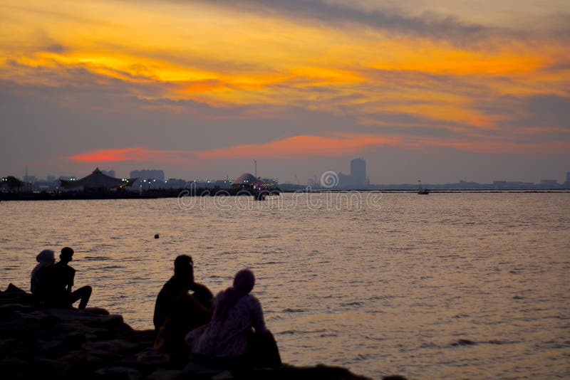 Sunset View on the Beach and Sunset Shadow of People Sitting Stock ...