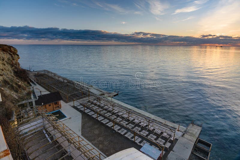 Sunset View on an Empty Sunlounge Beach on a Rocky Sea Shore Stock ...
