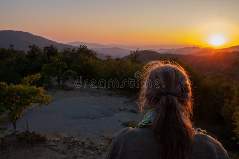 The Girl is Looking Down into a Mountain Valley at Sunset Stock Photo ...