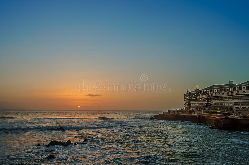 Sunset view by the ocean stock photo. Image of sunrise - 187410218