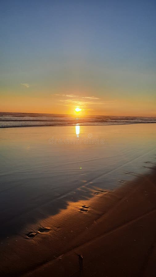 Sunset View at a Sand Beach with Full Sun and Reflectios in Water and ...