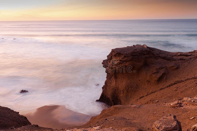 Sunset on Volcanic Beach with Sea in the Background Stock Image - Image ...