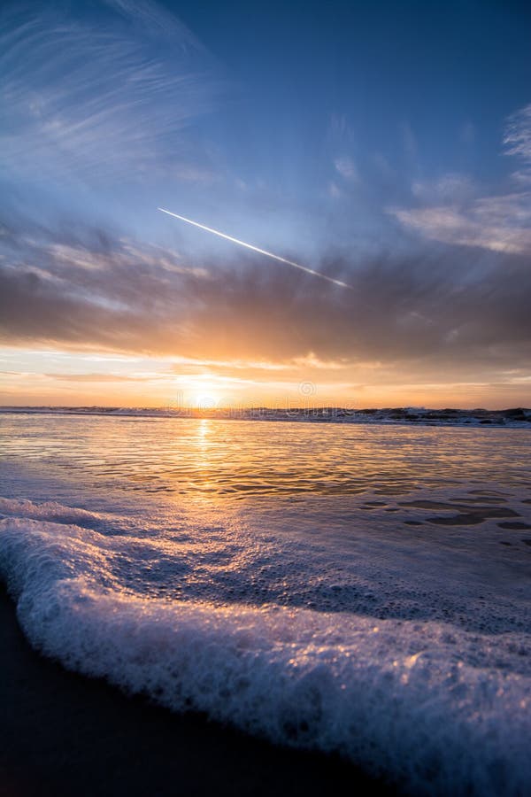 Sunset and Water Reflection on Beach Stock Image - Image of breakwater ...