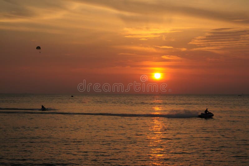 Sunset and water sport stock photo. Image of silhouette - 5519502