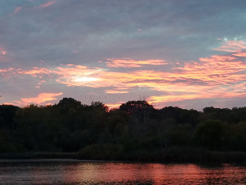 Sunset on the Water stock photo. Image of treeline, nightfall - 114595476