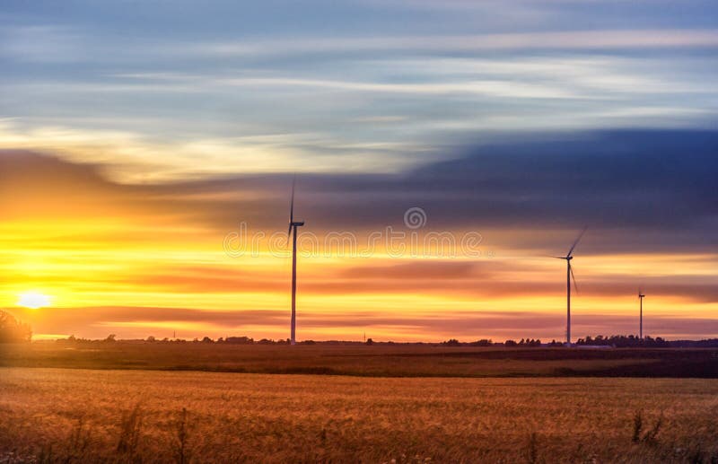 Sunset and Wheat Field with Windmill in Background. Stock Image - Image ...