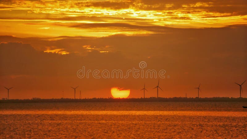 Sunset with wind turbines stock photo. Image of evening - 277653320