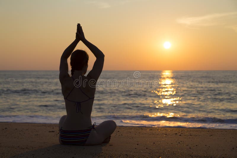 Young Woman Practicing Yoga on the Beach at Sunset Stock Photo - Image ...