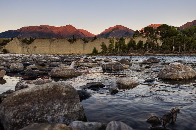 Sunsetting on Mountains, Close Up of Large River Rocks and River ...