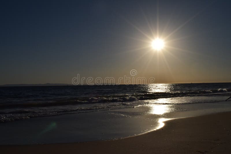 Sunsetting Over the Ocean Horizon Line. Stock Photo - Image of sunrays ...