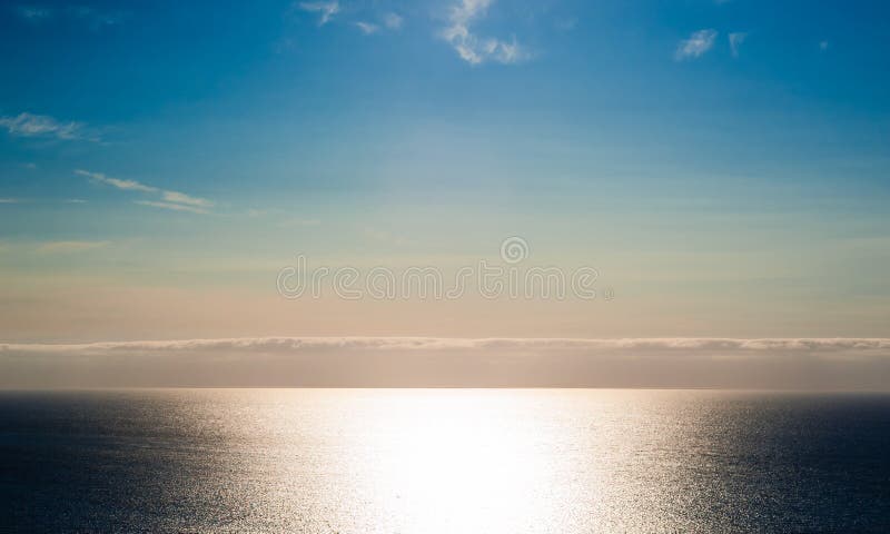 Sunshine on Empty Ocean with Cloud Layer and Colorful Sky Stock Photo ...