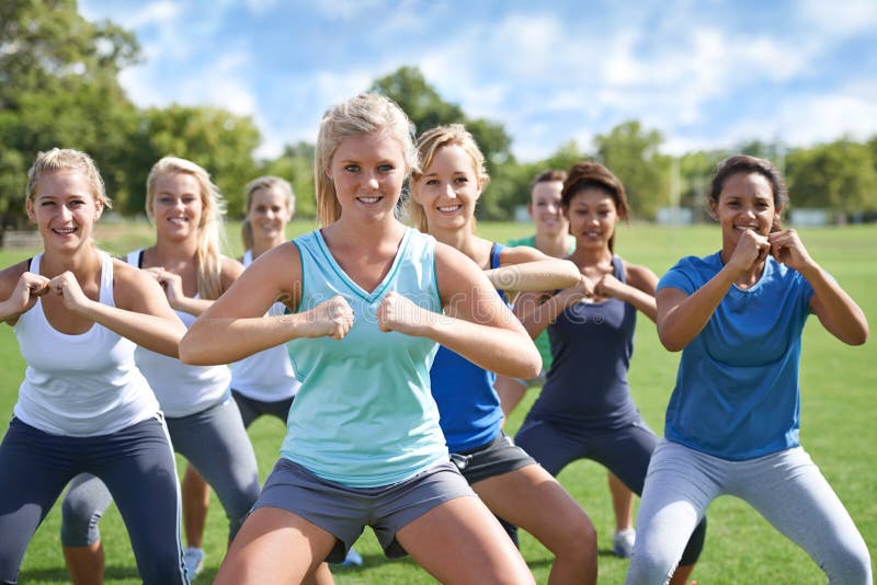Sunshine and Exercise. a Group of Young Women Exercising Outdoors ...
