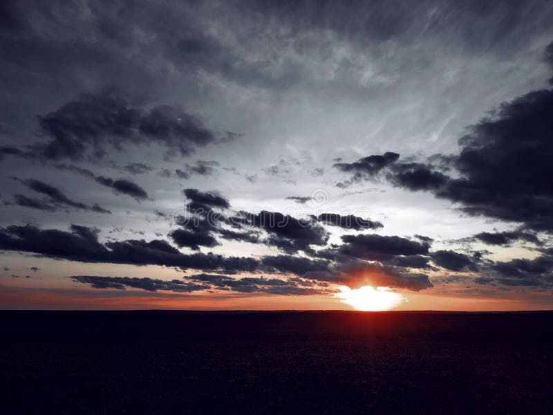 Sunshine at Sunset and Dark Clouds on the Horizon Stock Photo - Image ...