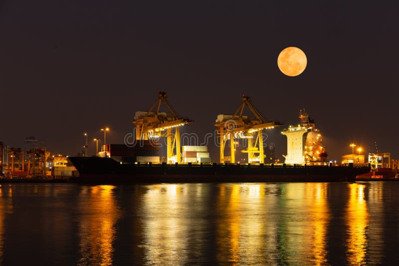 Super Moon and Cargo Containers Loading Shipping by Crane at Night Time ...