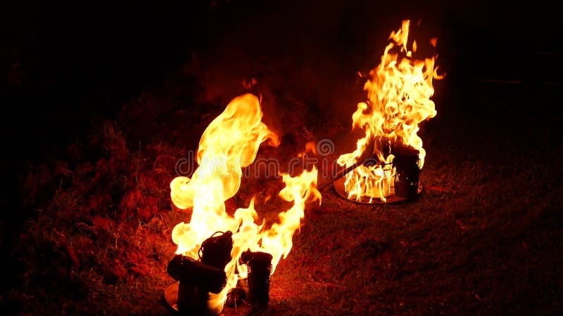 Super Slow Motion Bonfire at Night. Two Torches Lie on the Ground and ...