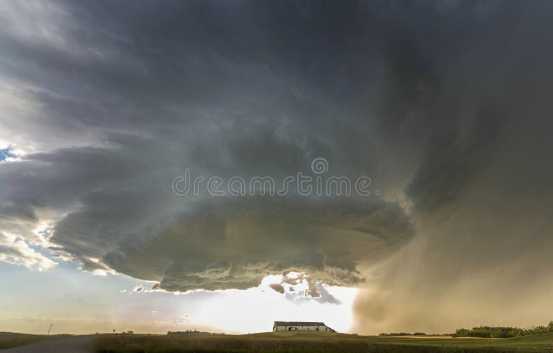 Supercell Storm Clouds Forming Over Farm at Sunset Stock Photo - Image ...