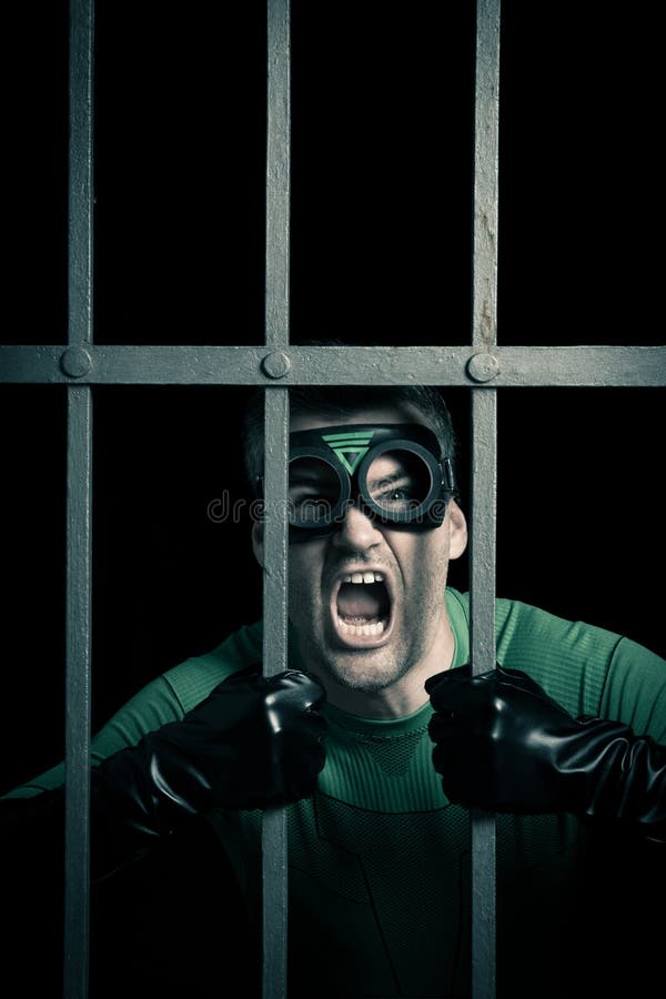 Superhero locked in prison stock photo. Image of goggles - 47767012