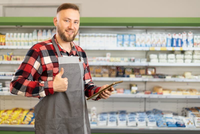 Supermarket Clerk Using Apps on a Digital Tablet, Innovative Technology ...