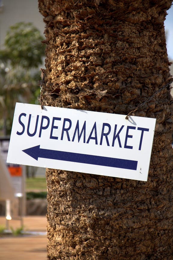 Supermarket Sign on Tree Trunk Stock Photo - Image of closeup, hanging ...