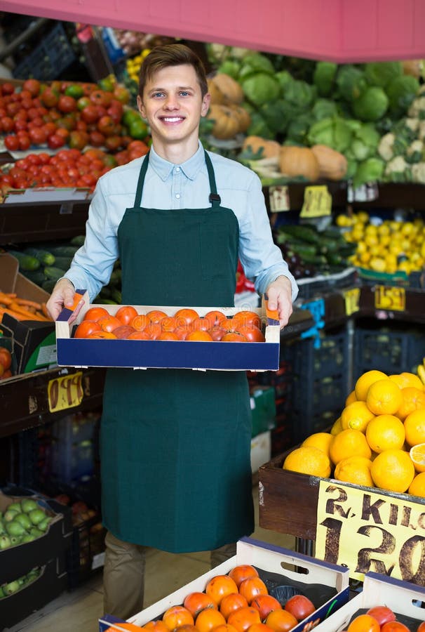 Supermarket Worker in Fruit Section Stock Photo - Image of oranges ...