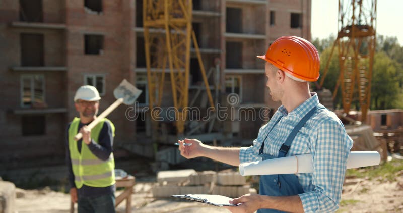 Superviser with Blueprint Standing at Construction Site Stock Footage ...