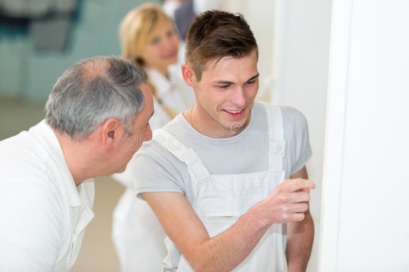 Supervising Painter Apprentice at Work Stock Photo - Image of angle ...