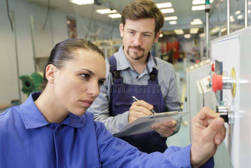 Supervisor Assessing Female Factory Worker Using Machinery Stock Image ...