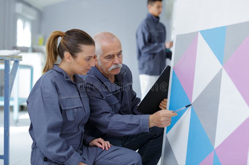 Supervisor Assessing Trainee Decorators Work Stock Image - Image of ...