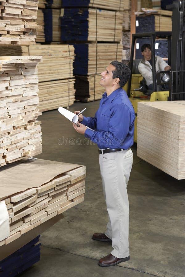 Supervisor Checking Notes in Warehouse Stock Photo - Image of stack ...