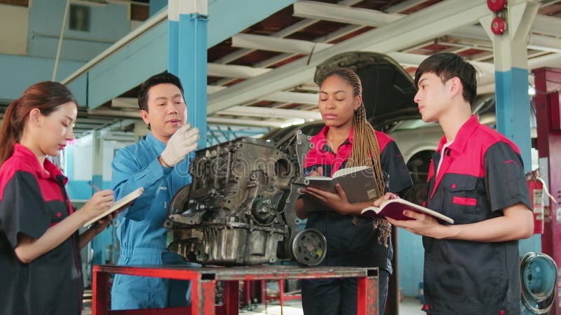 Supervisor Engineer is Teaching Mechanic Workers about Car Engines at a ...