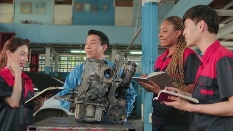 Supervisor Engineer is Teaching Mechanic Workers about Car Engines at a ...