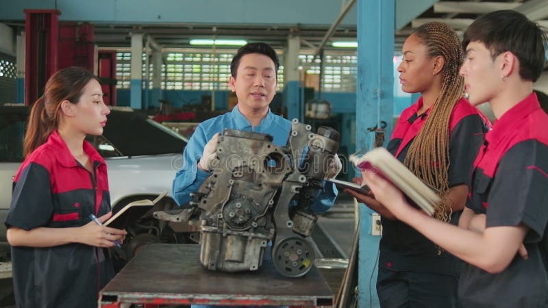 Supervisor Engineer is Teaching Mechanic Workers about Car Repair at a ...