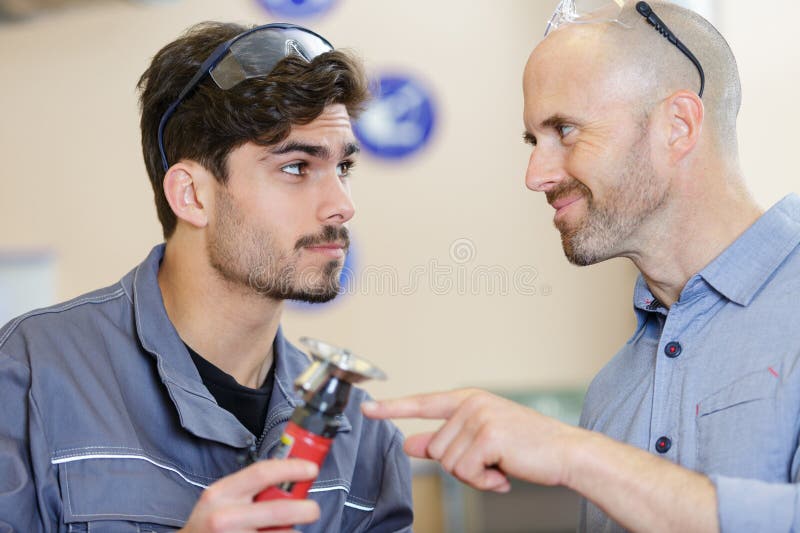 Supervisor Explaining Device To Apprentice Worker Stock Photo - Image ...