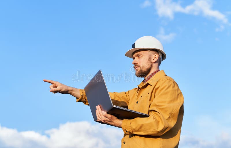 Supervisor in Helmet Using Laptop Showing with Hand Gesture Stock Photo ...