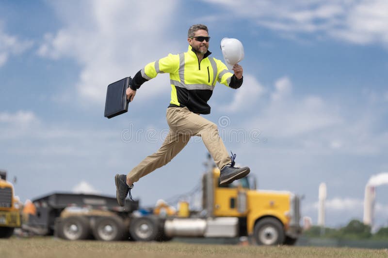Supervisor Jumping. Excited Builder Construction Worker Jumping at ...