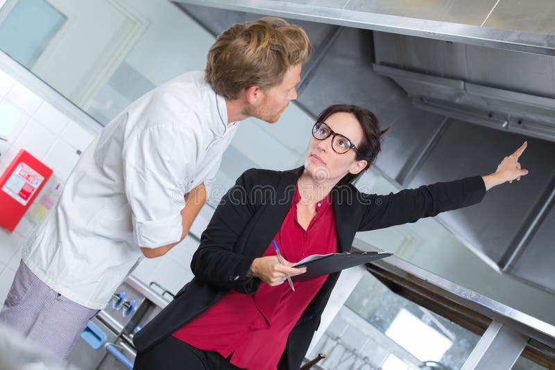 Supervisor Pointing at Problem in Kitchen Stock Image - Image of ...