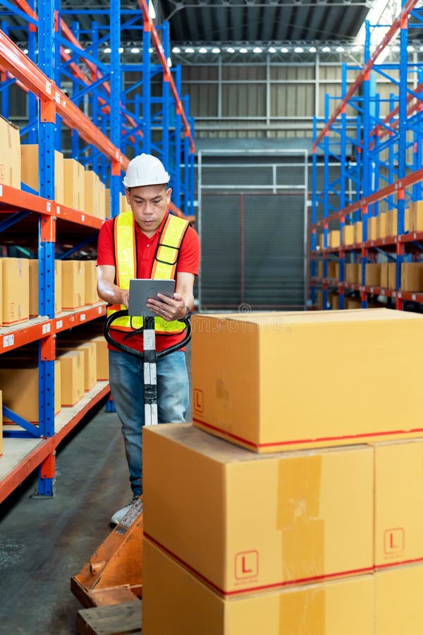 Supervisor Standing in Warehouse with Tablet in Hands and Checking Out ...