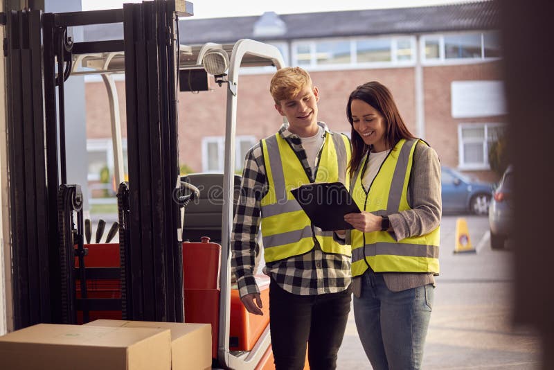 Supervisor Teaching Intern To Operate Fork Lift Truck in Modern ...