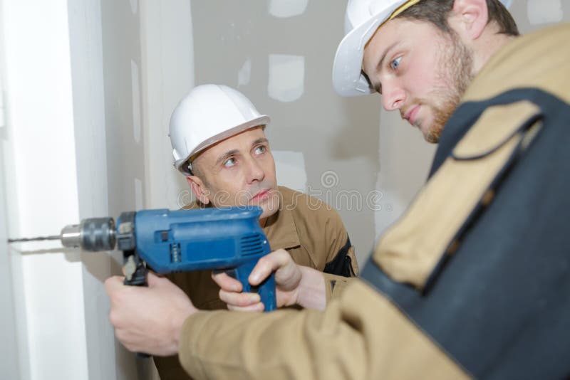 Supervisor Watching Trainee Work on Machine Stock Photo - Image of ...