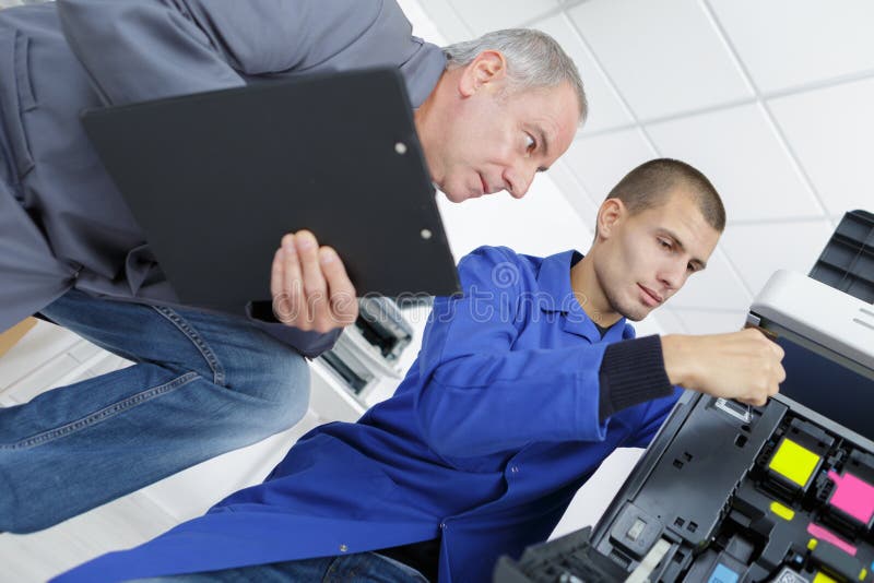 Supervisor Watching Technician Work on Photocopier Stock Image - Image ...