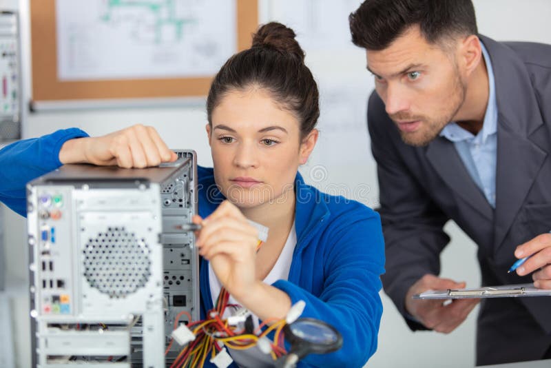 Supervisor Watching Young Female Apprentice Working on Computer Stock ...