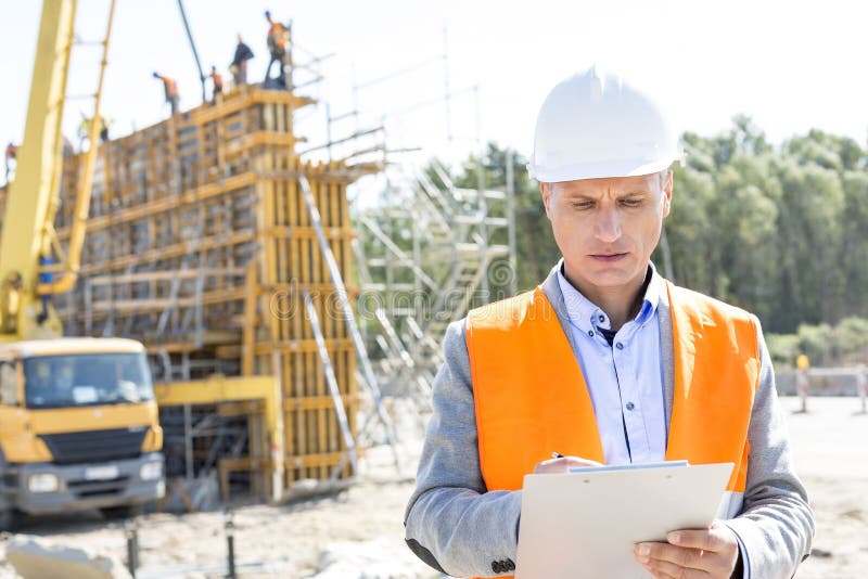 Supervisor Writing on Clipboard at Construction Site Stock Image ...