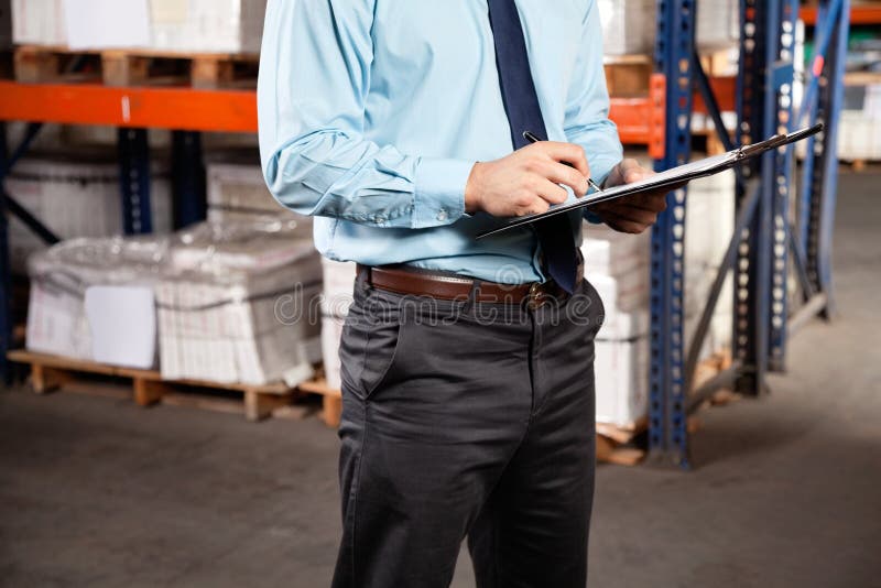 Supervisor Writing on Clipboard at Warehouse Stock Photo - Image of ...