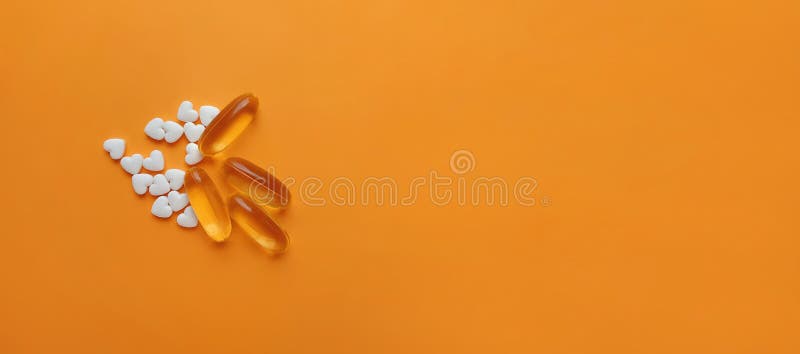 Supplements and Vitamins on an Orange Background with Copy Space. Top ...