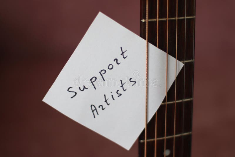 Support Artists Note Attached To Acoustic Guitar Stock Image - Image of ...
