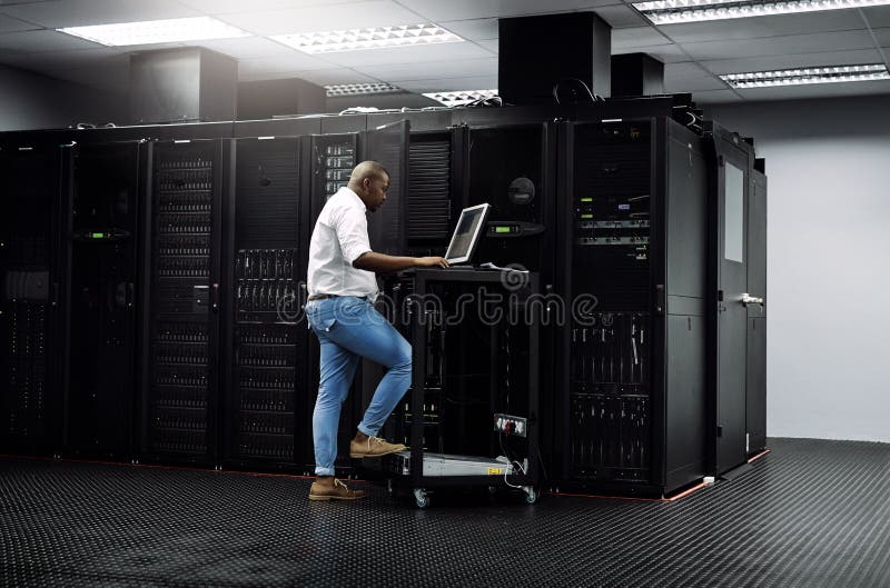 It Support Black Man Or Coding On Computer In Server Room For Big Data