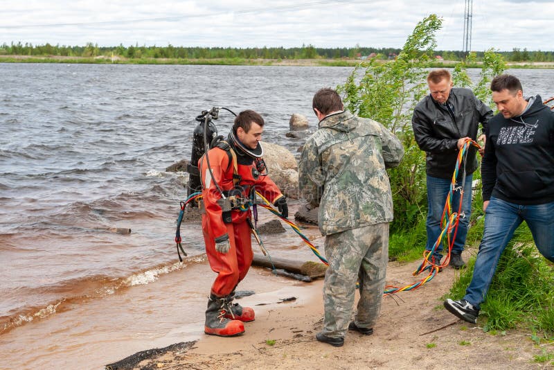 The Support Team Helps the Diver Prepare for Deep-sea Work Editorial ...